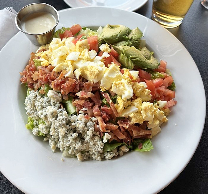 A salad that breaks the "boring greens" stereotype with a colorful cast of avocado, egg, and bacon stealing the show.
