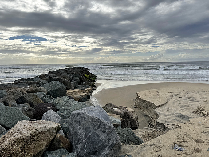 Waves crash gently against the rocky jetty at Sand Dollar Beach, creating a peaceful Imperial Beach scene to enjoy.