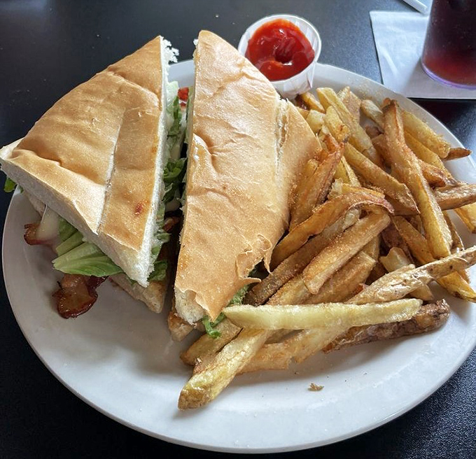 This sandwich isn't just lunch; it's architecture &ndash; layers of goodness between bread with fries so perfectly golden they deserve their own spotlight.