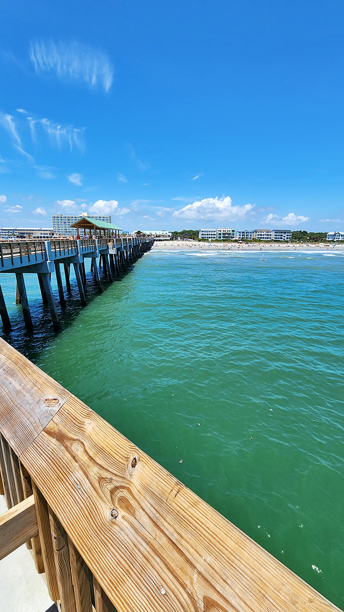 Boardwalk reflections create mirror images of weathered wood, where every plank tells stories of salt-kissed summers.