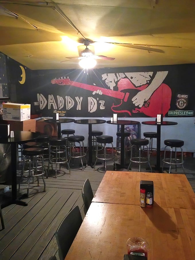 The late-night ambiance at Daddy D'z features moody lighting and a guitar mural that hints at the soul behind the smoke.