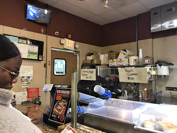 Signs for "Honey Magic Bread" and "Peach Cobbler" remind us that barbecue joints often hide dessert treasures worth saving room for.