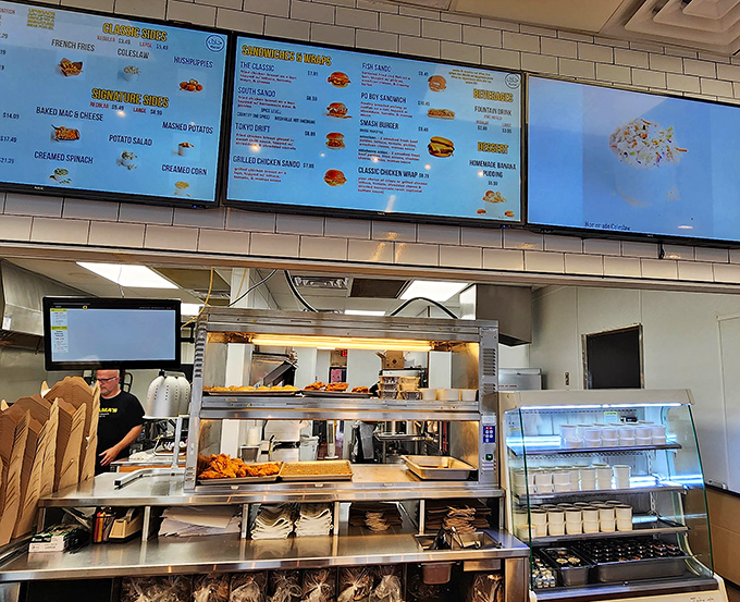Digital menus showcase the possibilities while the kitchen crew works their crispy, golden magic just beyond the counter.