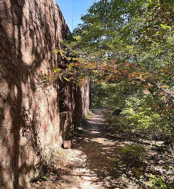 Walking through time. This narrow passage between towering quarry walls feels like stepping into Missouri's industrial past.