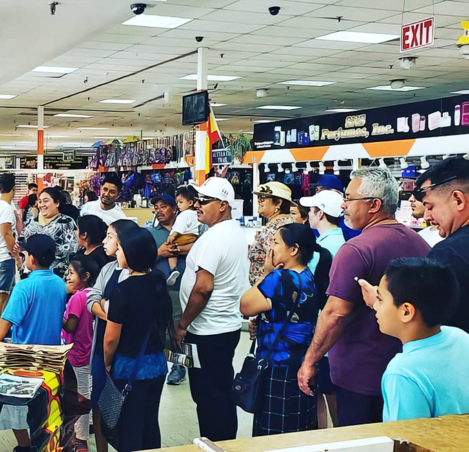 Fellow treasure hunters navigate the aisles with the focused determination of seasoned bargain archaeologists.