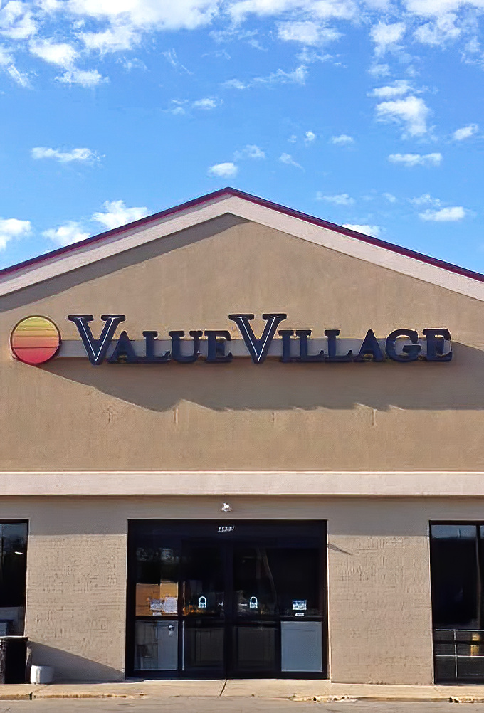 Value Village against blue skies: a beacon of bargain hunting that promises treasures within its humble exterior.