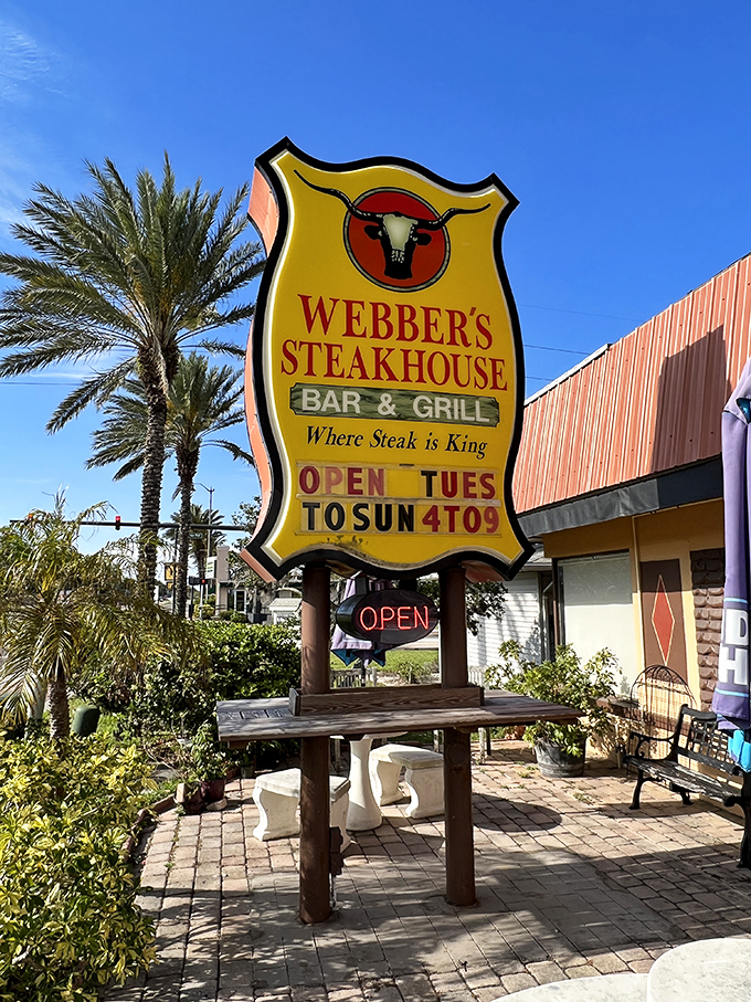The sign proclaims "Where Steak is King" with the confidence of a place that's been proving it for years. Palm trees add that quintessential Florida frame.