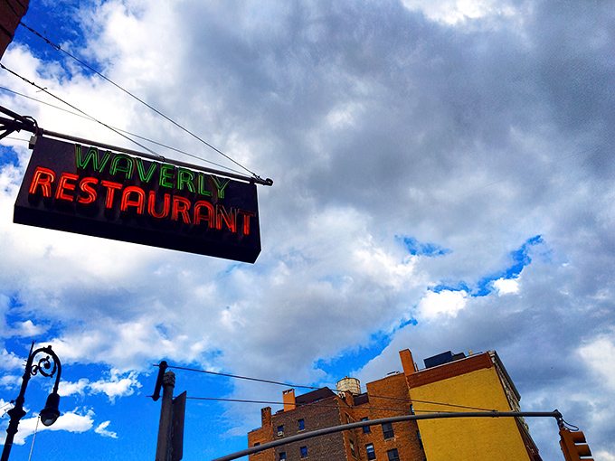 The classic neon "Restaurant" sign beckons hungry souls like a lighthouse guides ships home.