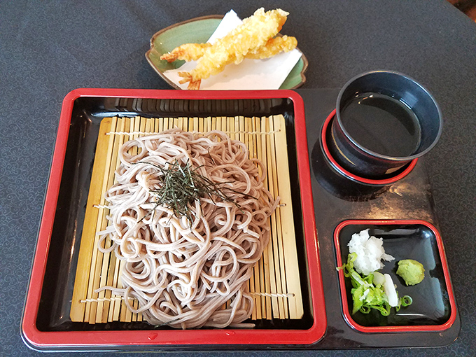 Soba noodles arranged with the care of a Zen garden, accompanied by tempura and dipping sauce. Simplicity that speaks volumes without saying a word.