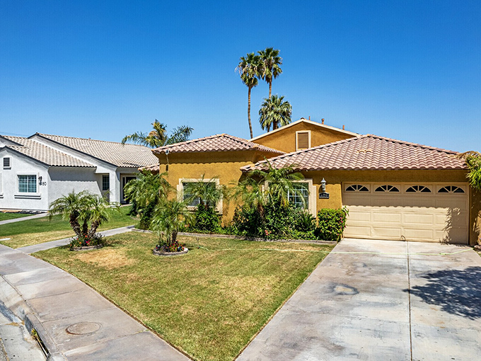 Spanish-style homes with terracotta roofs bring Mediterranean flair to the desert, their neat lawns defying the surrounding sand.