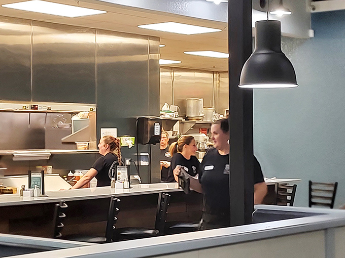 The kitchen crew in their element &ndash; where the magic happens behind a symphony of sizzles, clangs, and occasional bursts of flame.
