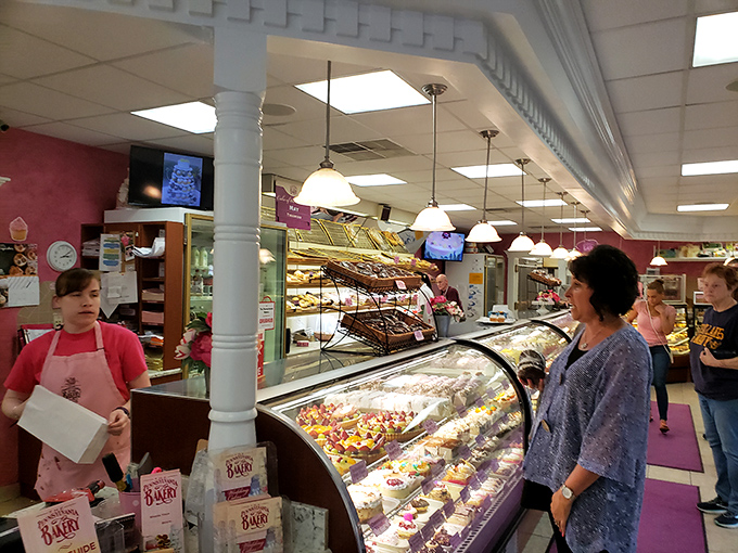 Staff members helping customers navigate the sweet paradise - heroes without capes, but with aprons.