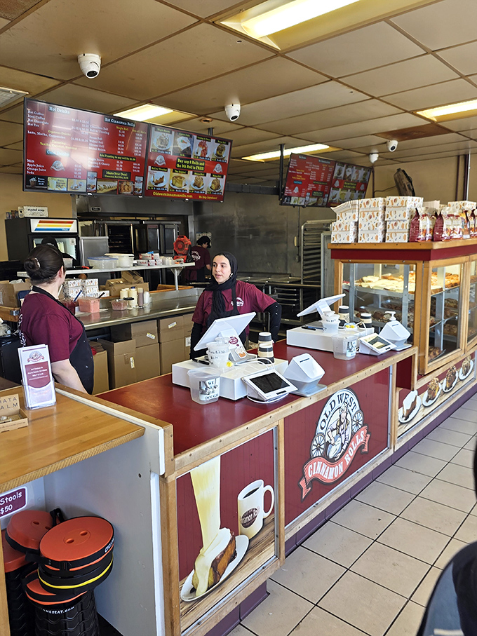 The front counter—where dreams come true and diets go to die. Those staff uniforms have witnessed countless expressions of pastry ecstasy.