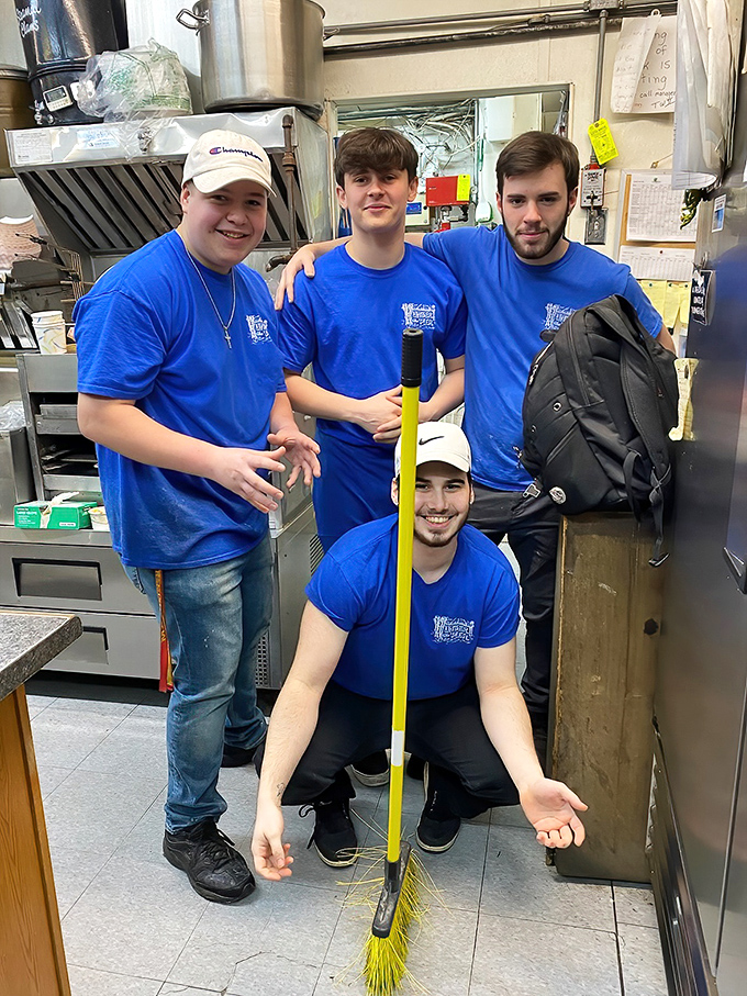 The cheerful crew behind the magic, turning fresh catches into golden treasures with infectious enthusiasm.