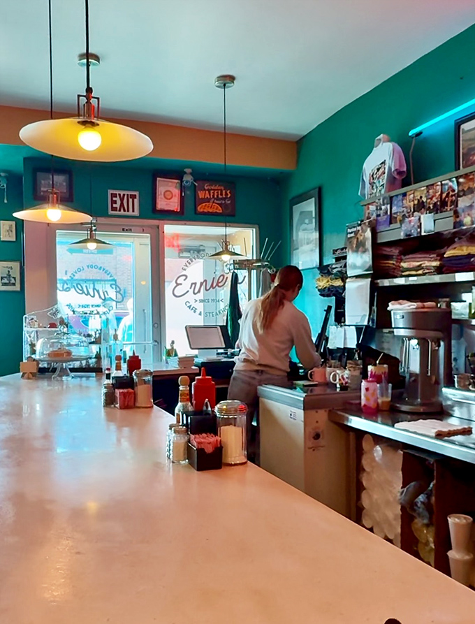 Morning light streams through the windows, illuminating a workspace where breakfast magic happens with practiced efficiency and zero pretension.