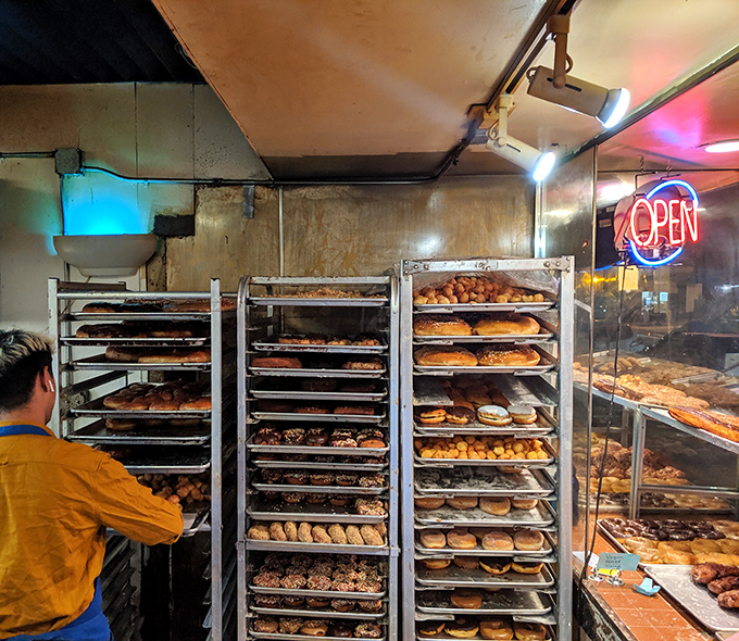 Racks upon racks of freshly made donuts await their destiny &ndash; to disappear into pink boxes and happy stomachs across San Francisco.