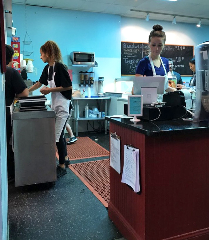 The staff works their custard alchemy with practiced precision. These are the wizards behind your frozen happiness.