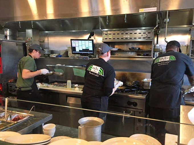 The kitchen crew works with the synchronized precision of a championship rowing team. Breakfast champions in their natural habitat.