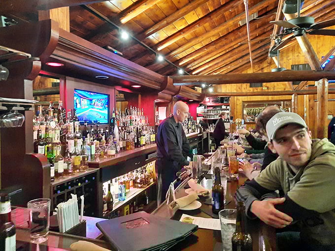 The bustling bar area offers front-row seats to mixology magic, where bartenders transform ordinary ingredients into extraordinary cocktails.