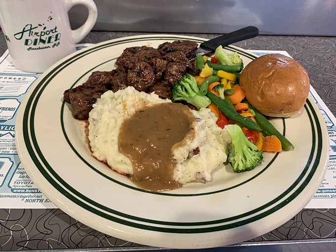 Steak tips that deliver on their promise, alongside mashed potatoes standing by for their gravy baptism and vegetables providing a pop of color.