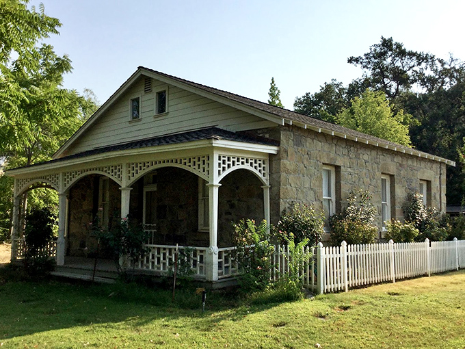 This charming stone cottage looks like it should be on the cover of "Retirement Goals Monthly"—complete with white picket fence perfection.