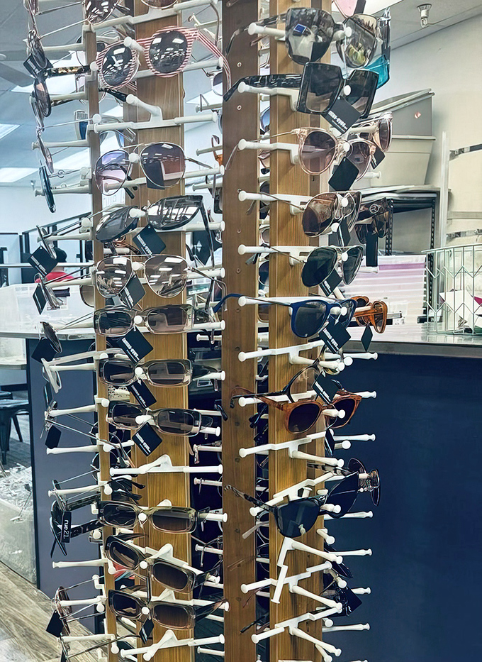 Sunglasses galore on their wooden carousel of cool&mdash;instant personality upgrades spinning lazily, waiting for their moment in the sun.