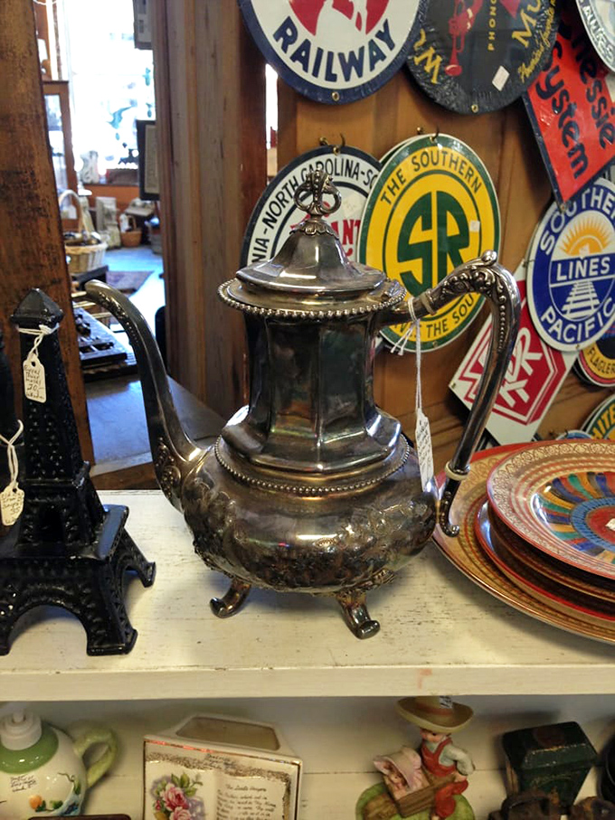 Silver teapots like this once presided over proper conversations and improper gossip, surrounded by railway memorabilia from America's golden age of travel.