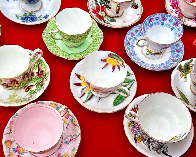 Tea time elegance spread across crimson cloth! These delicate cups have hosted countless conversations and consolations, ready to steep new memories in your home.