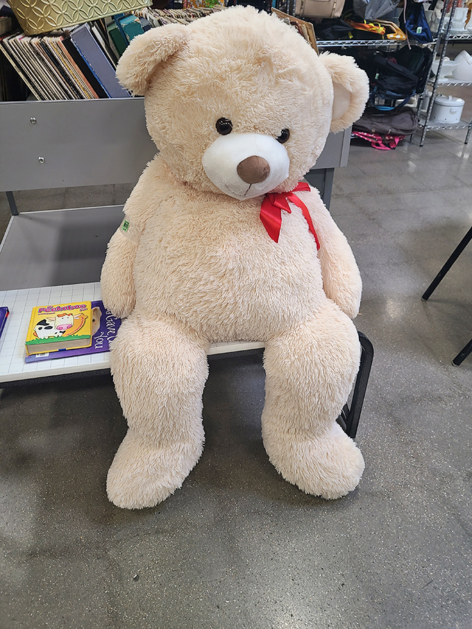 This giant teddy bear sits patiently waiting for his forever home, like a fluffy ambassador welcoming you to the toy section.