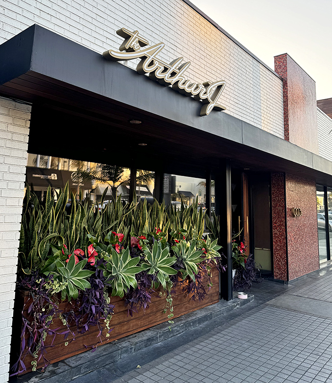 The Arthur J's sleek exterior hints at the sophisticated steakhouse experience within, where mid-century modern meets meat-lover's paradise.