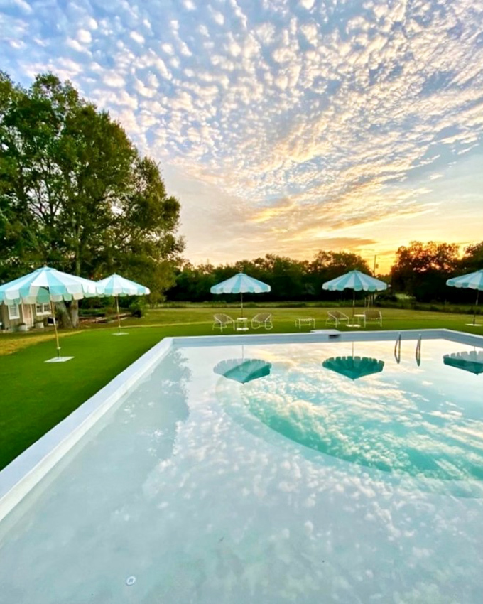 A Texas sunset transforms this swimming pool into a mirror for cotton-candy clouds - small-town luxury at its finest.