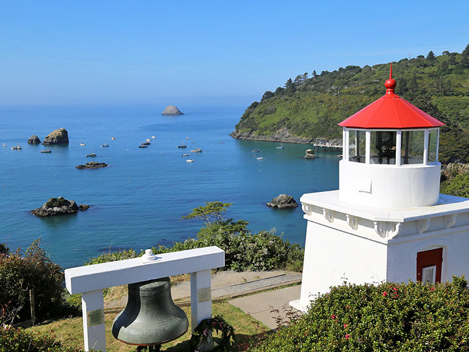The Trinidad Memorial Lighthouse stands guard over fishing boats like a proud parent watching their children play in the harbor below.