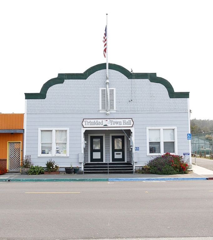 Trinidad's Town Hall wears its distinctive roofline like a crown, civic pride wrapped in coastal architecture that says "we're not your average town." 