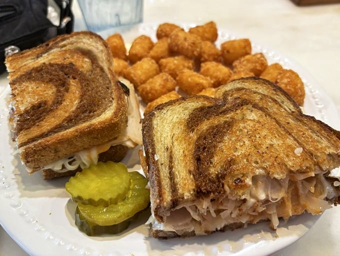 This isn't just a sandwich – it's architecture with pickle garnish. Layers of turkey and melted cheese between perfectly grilled marble rye create edible engineering.