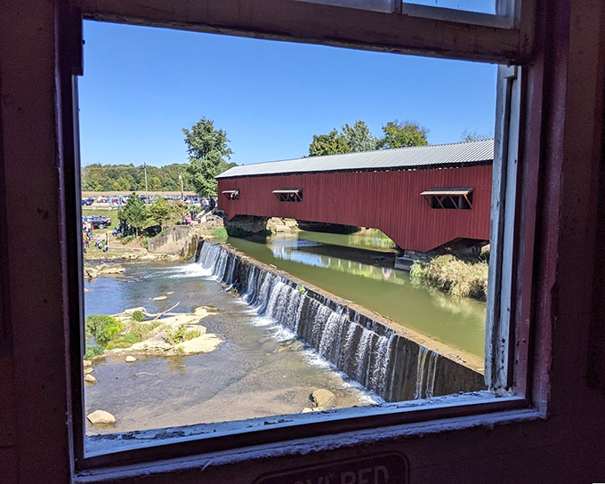 This window view from the mill frames the waterfall and bridge perfectly, proving that Instagram-worthy vistas existed long before Instagram.
