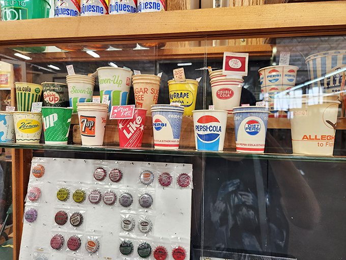 Vintage soda cups and bottle caps transport you to drive-ins and soda fountains. 7-Up, Pepsi, and Coca-Cola branding from simpler times.