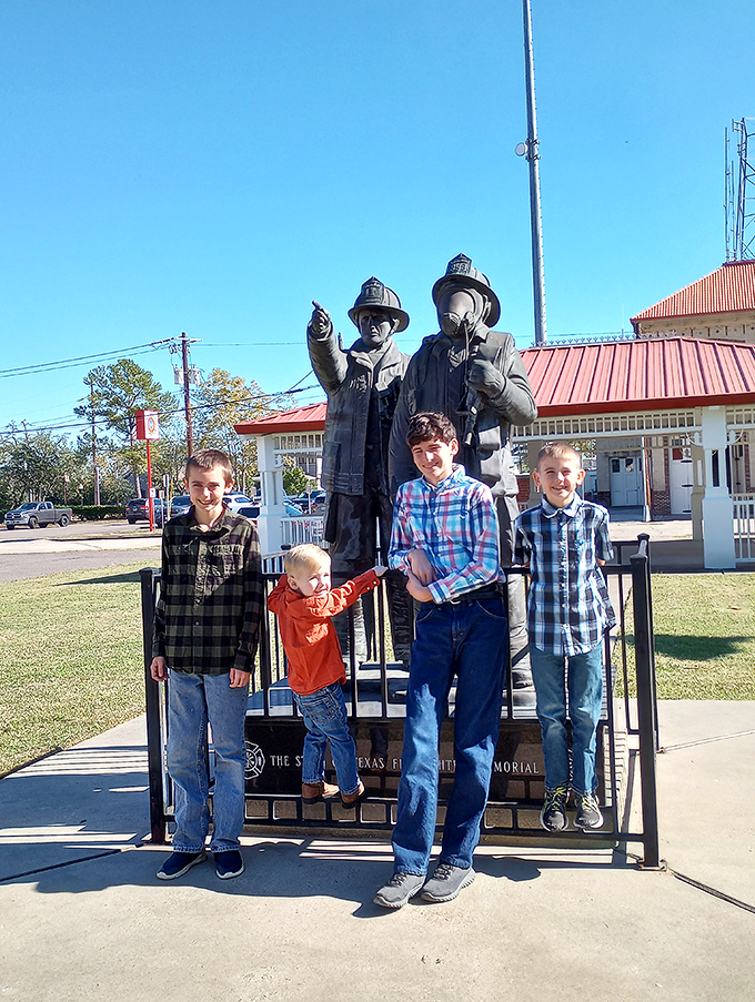 Four generations discovering that the best family photos always include at least one really big fire hydrant.