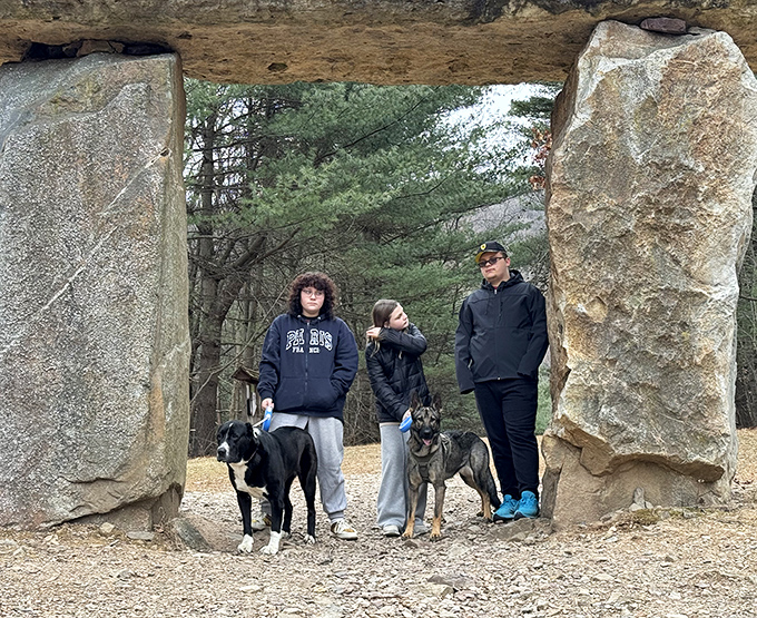Stone gateways invite exploration and frame perfect memories. Dogs and their humans pause to appreciate this threshold between ordinary and extraordinary worlds.