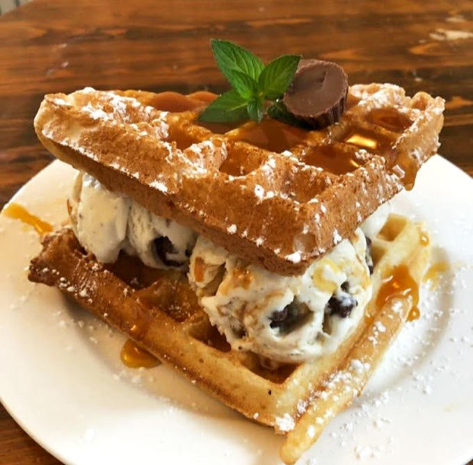 Not just a waffle—a waffle sundae embracing ice cream in a powdered-sugar dusted hug. The mint leaf is just showing off at this point.