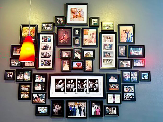 A wall of memories tells you this isn't just a restaurant—it's someone's life work. Each frame represents thousands of satisfied customers over the years.