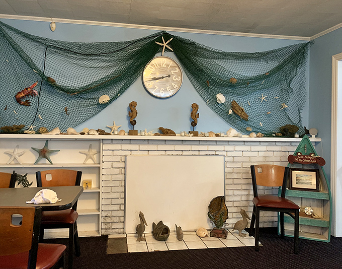 The fishing net wall display isn't kitschy decoration—it's practically a family photo album in this authentic seafood joint. Those starfish have seen some happy diners.