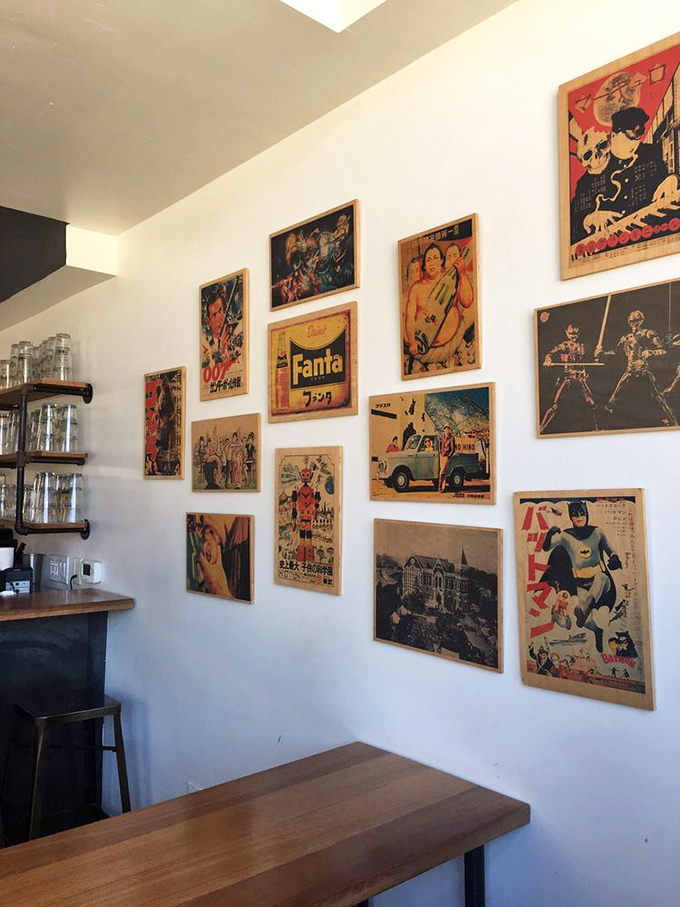Vintage Japanese pop culture posters create a gallery wall that's as thoughtfully curated as the menu itself.