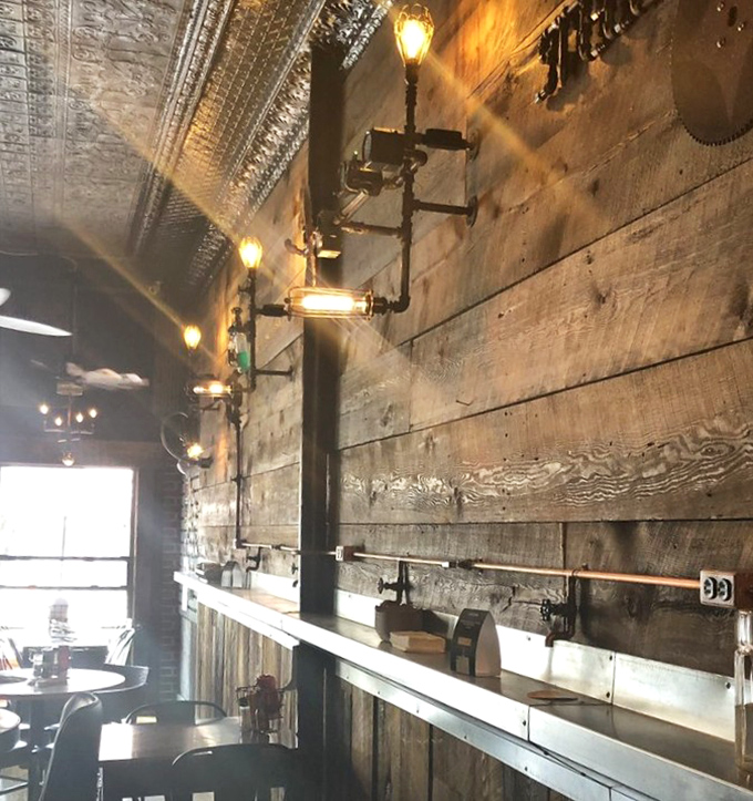 Industrial-chic lighting fixtures illuminate reclaimed wood walls &ndash; Edison would approve of both the bulbs and the atmosphere they create.