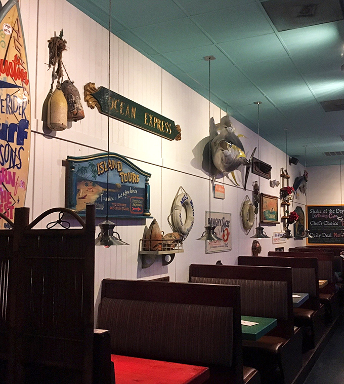 Maritime memorabilia transforms dining walls into a coastal museum where every artifact tells a story between bites.