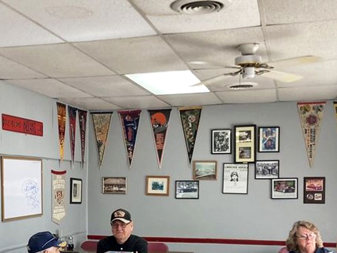 Sports pennants and local memorabilia tell stories that Yelp reviews never could. These walls have absorbed decades of neighborhood news.