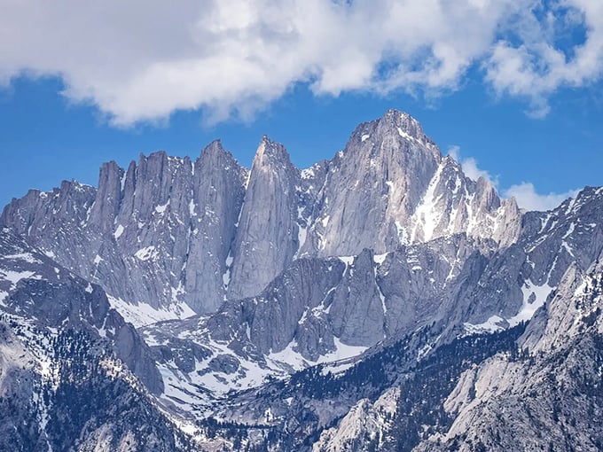 Mount Whitney towers majestically in the distance, its granite spires reaching skyward like nature's own cathedral.
