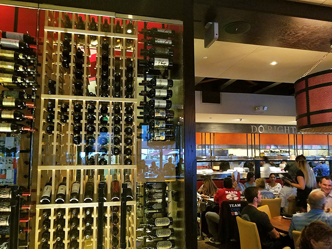 Wine bottles stand at attention like soldiers guarding flavor. Each one waiting for its moment to complement the ocean's bounty.