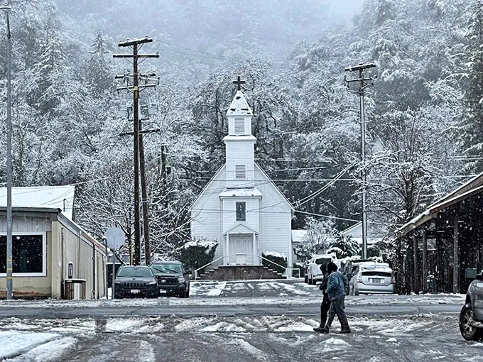 Snow blankets the little white church, creating a winter wonderland that feels like you've wandered into a Norman Rockwell painting.