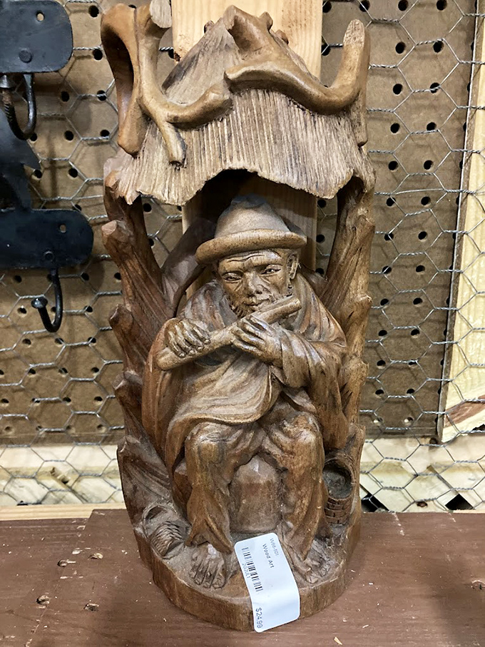 Folk art with character! This hand-carved wooden figure sits patiently, waiting for the right collector to appreciate its rustic charm and craftsmanship.