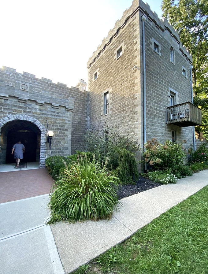 "Your chamber awaits, m'lord!" The castle entrance, flanked by lush greenery, promises adventures beyond its heavy wooden doors.